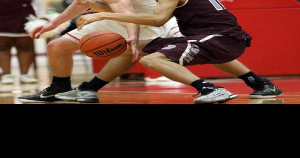 Munster's Kevin Schlotman tries to steal the ball from Bowman Academy's ...