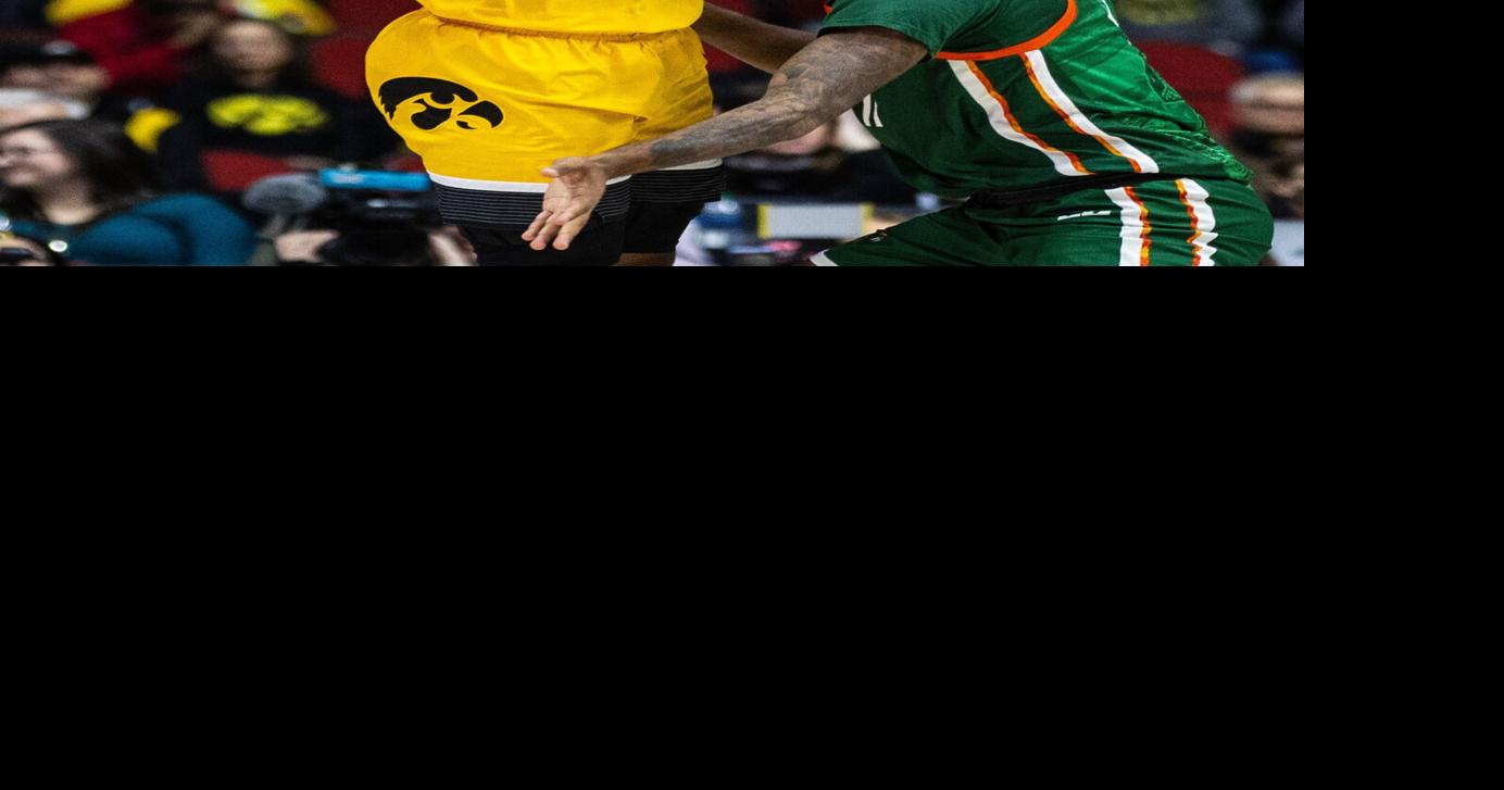 Iowa Hawkeyes guard Tony Perkins (11) is guarded by Florida A&M ...