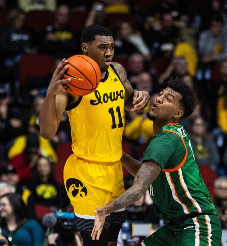 Iowa Hawkeyes guard Tony Perkins (11) is guarded by Florida A&M ...