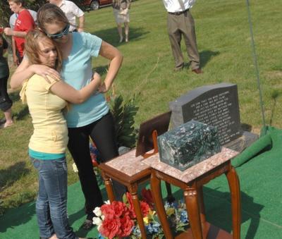 Year after killings, teen's ashes buried near Beason