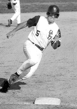Oakland City University's Erik Browning reaches third base on his way ...