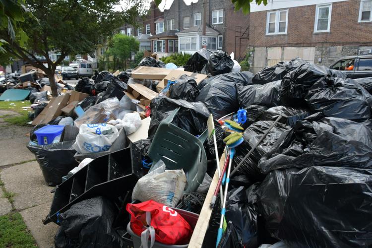 Trash piles for blocks: Work begins to clean up mounting garbage that ...