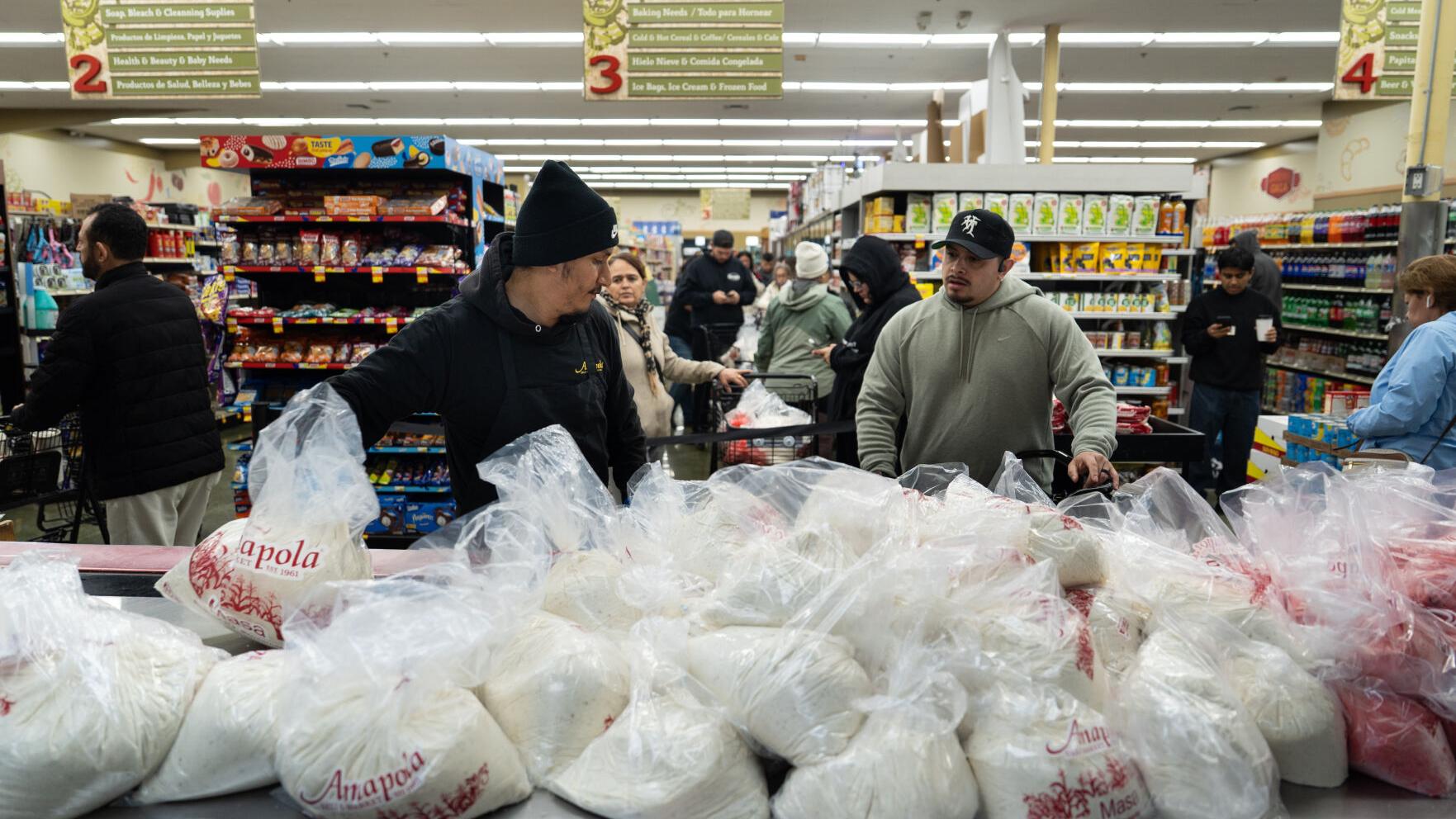 Families wait in line for hours to buy masa for Christmas tamales at ...