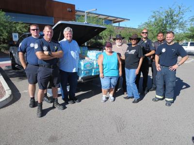 Baha’is donate water to police, firefighters | Area News | pinalcentral.com
