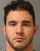 Police: Man fired gun into neighbor's apartment