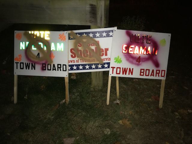 Two charged in connection with political sign vandalism