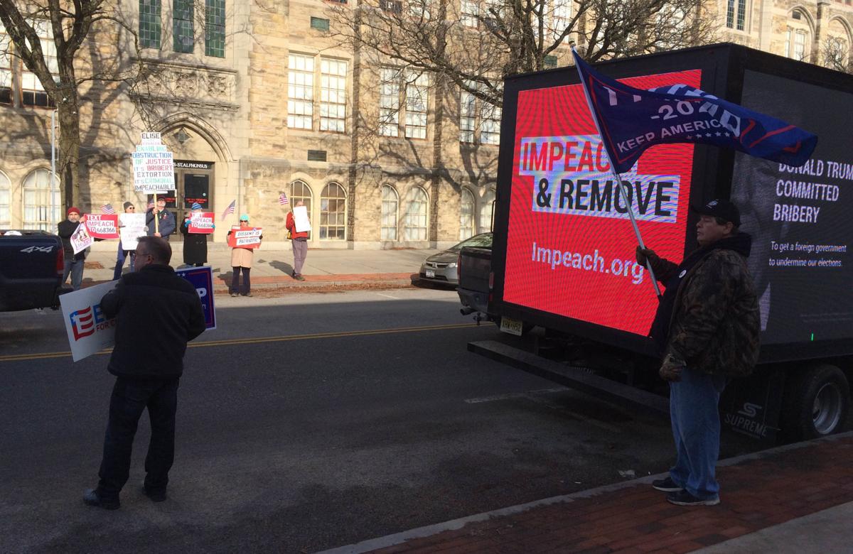 'Impeach' sign back on Tuesday after being shut down on Monday