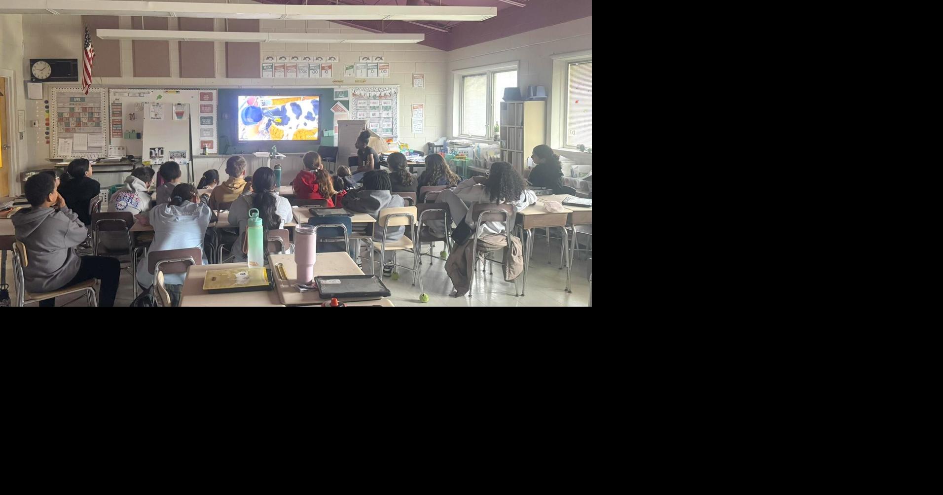 Middle Township students watch a cow grow