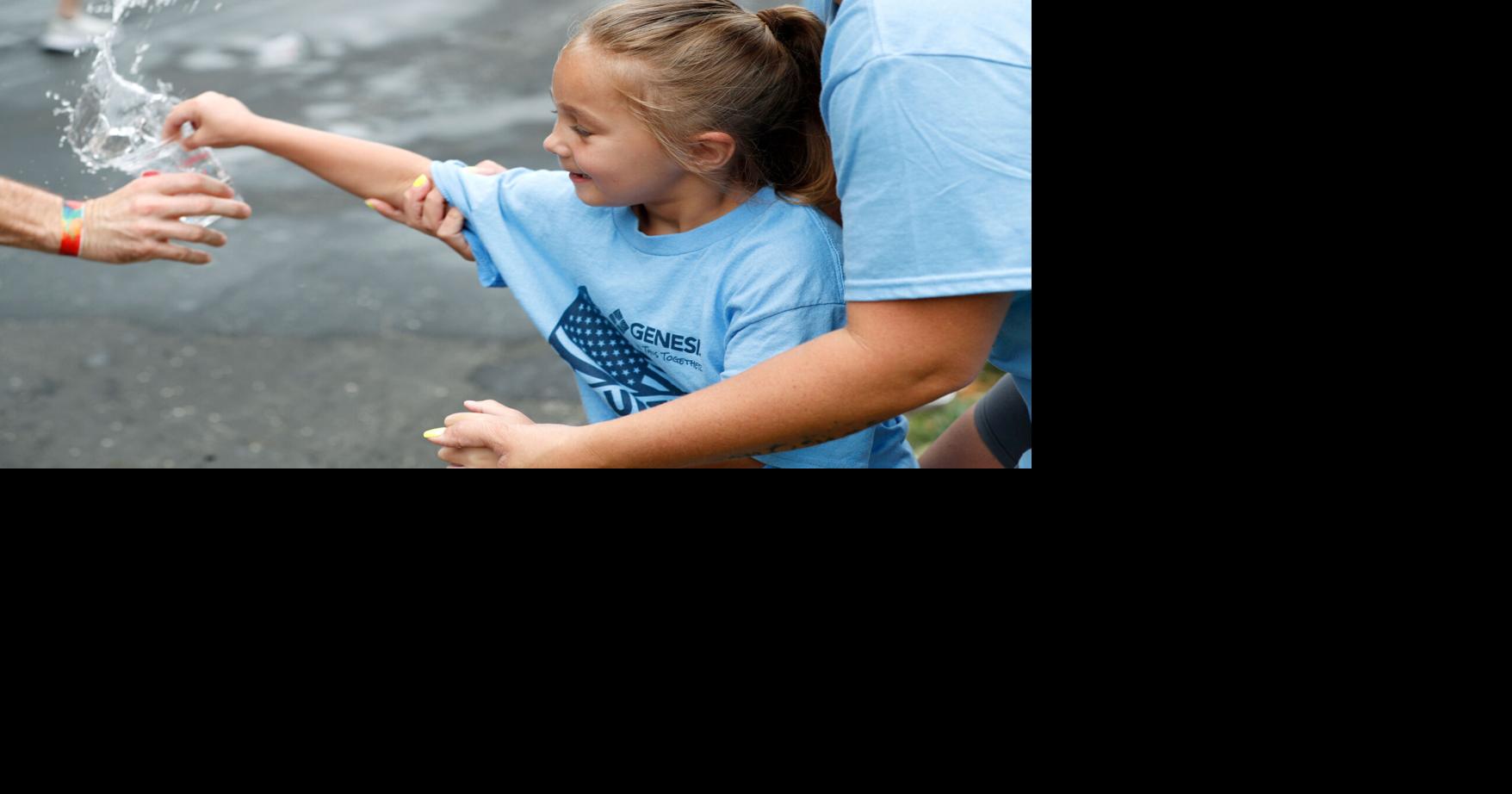 People gather at the turnaround to watch the Quad-City Times Bix 7 runners