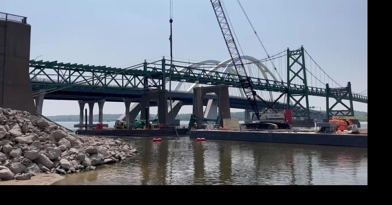 A piece of debris from old I-74 bridge falls back into water after ...