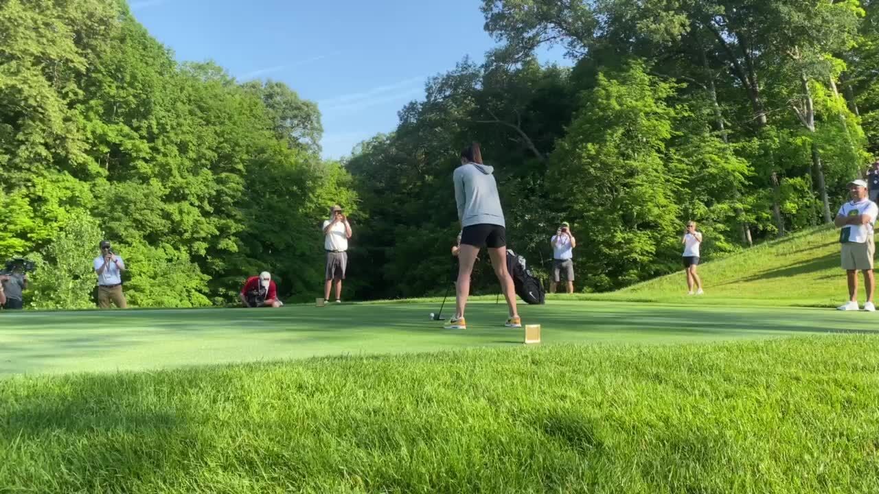 Caitlin Clark takes her first stroke at the John Deere Classic Pro-Am