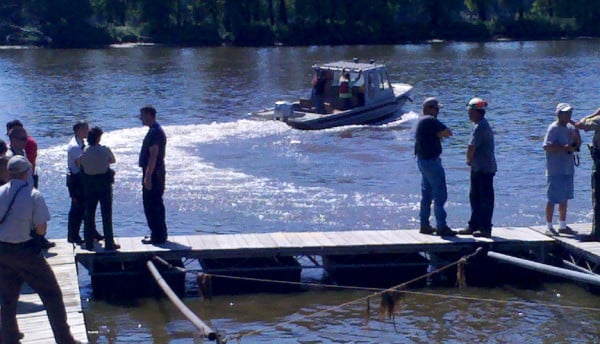 Workers rescue man who fell off barge into river