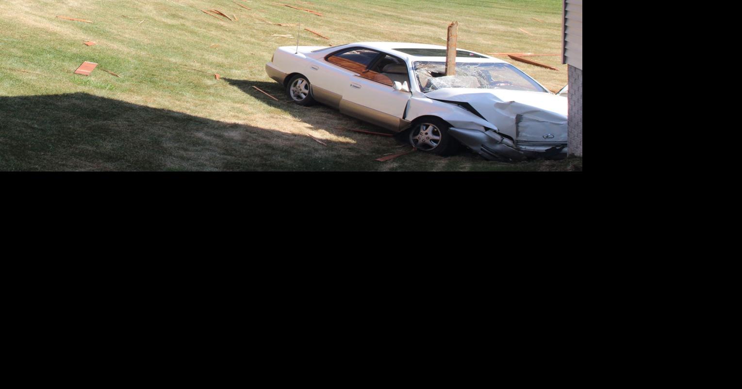 Woman injured when car crashes through fence, hits house