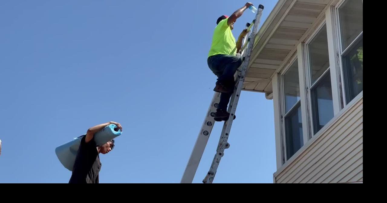 Roofers work in Tuesday’s heat