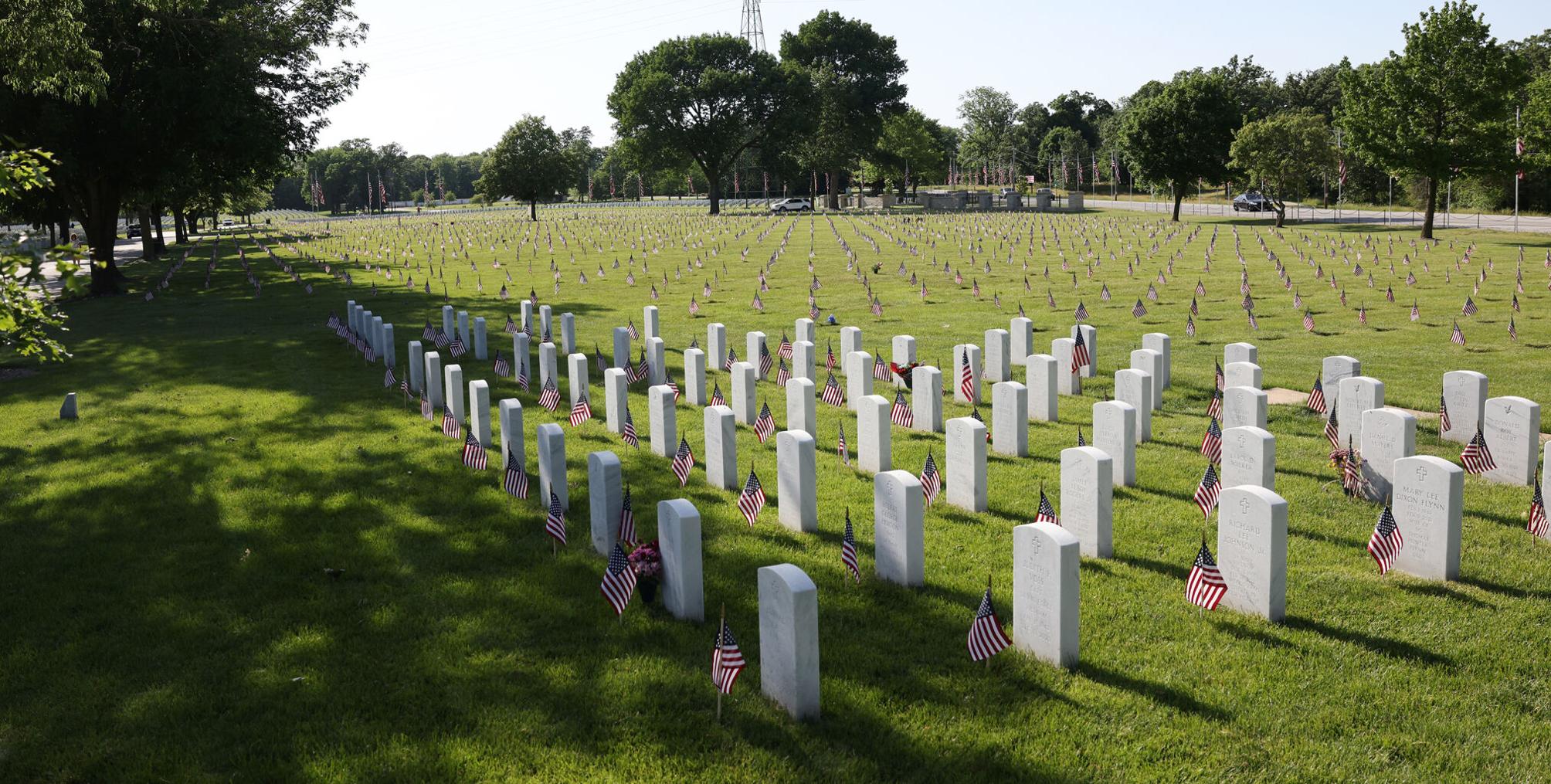 Volunteers place flags at Rock Island National Cemetery