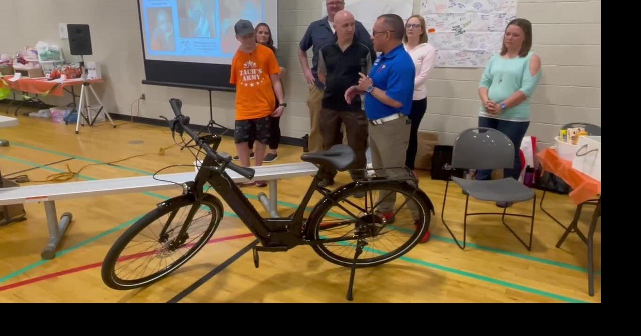 Cancer amputee Zack Maxwell receives electric bike during benefit ...