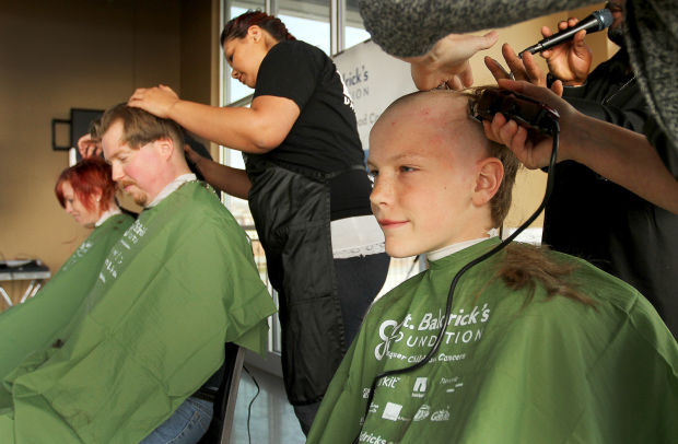 Scores shave heads for childhood cancer fight
