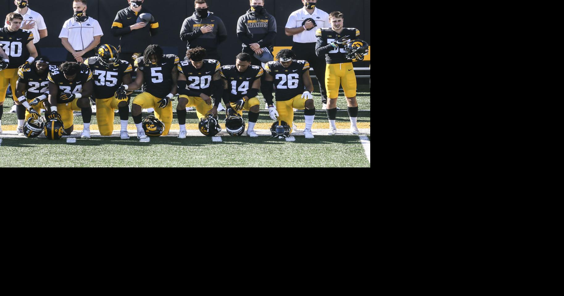Hawkeyes take a stand, kneel during anthem