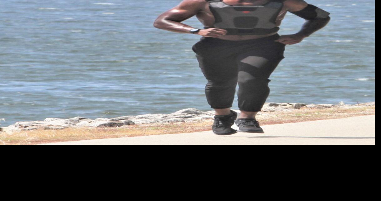 Despite the heat, Trey Blount of Davenport takes his run along the Mississippi River