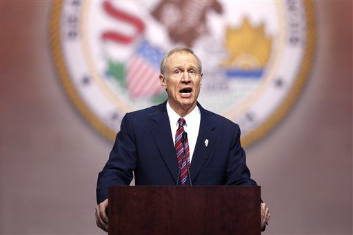 Bruce Rauner sworn into office; freezes non-essential spending