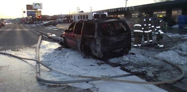 Woman arrested after minivan hits light pole, catches fire