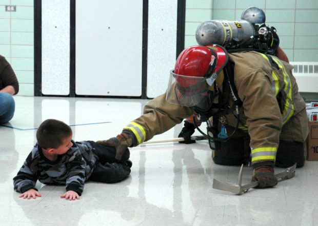Firefighters help kindergarteners learn about fire safety