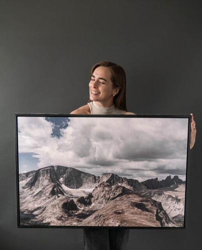 Ellen holding her art framed
