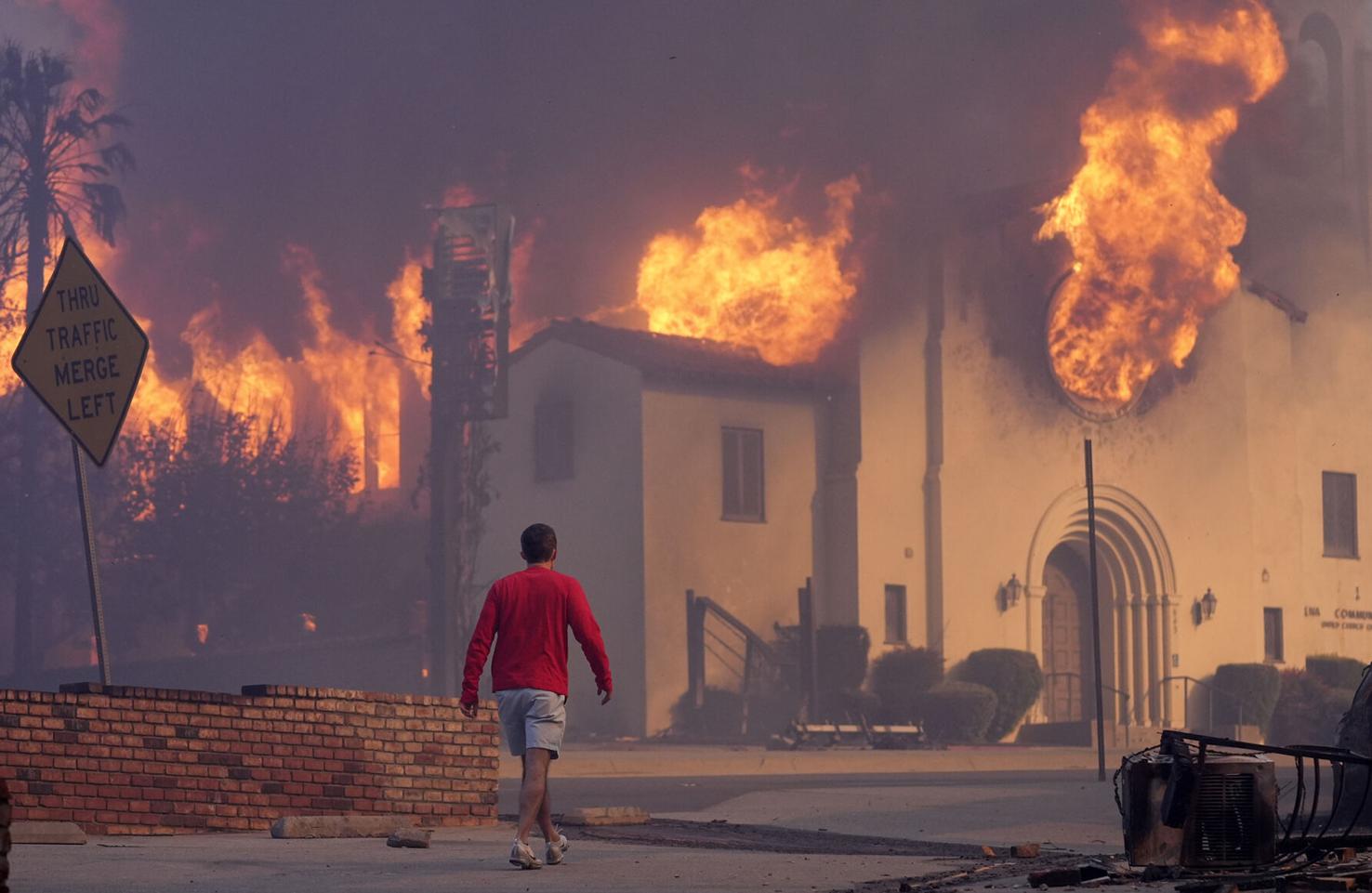 Wildfires burn across LA area and kill 2 as thousands flee