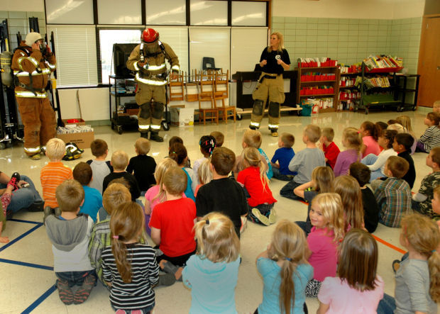 Firefighters help kindergarteners learn about fire safety