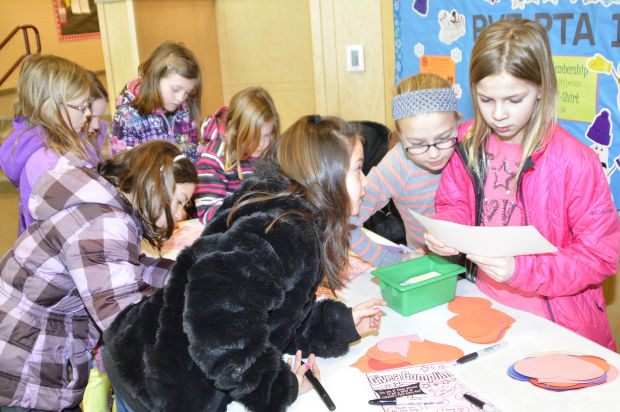 Students offer Valentine's cards to teach courtesy