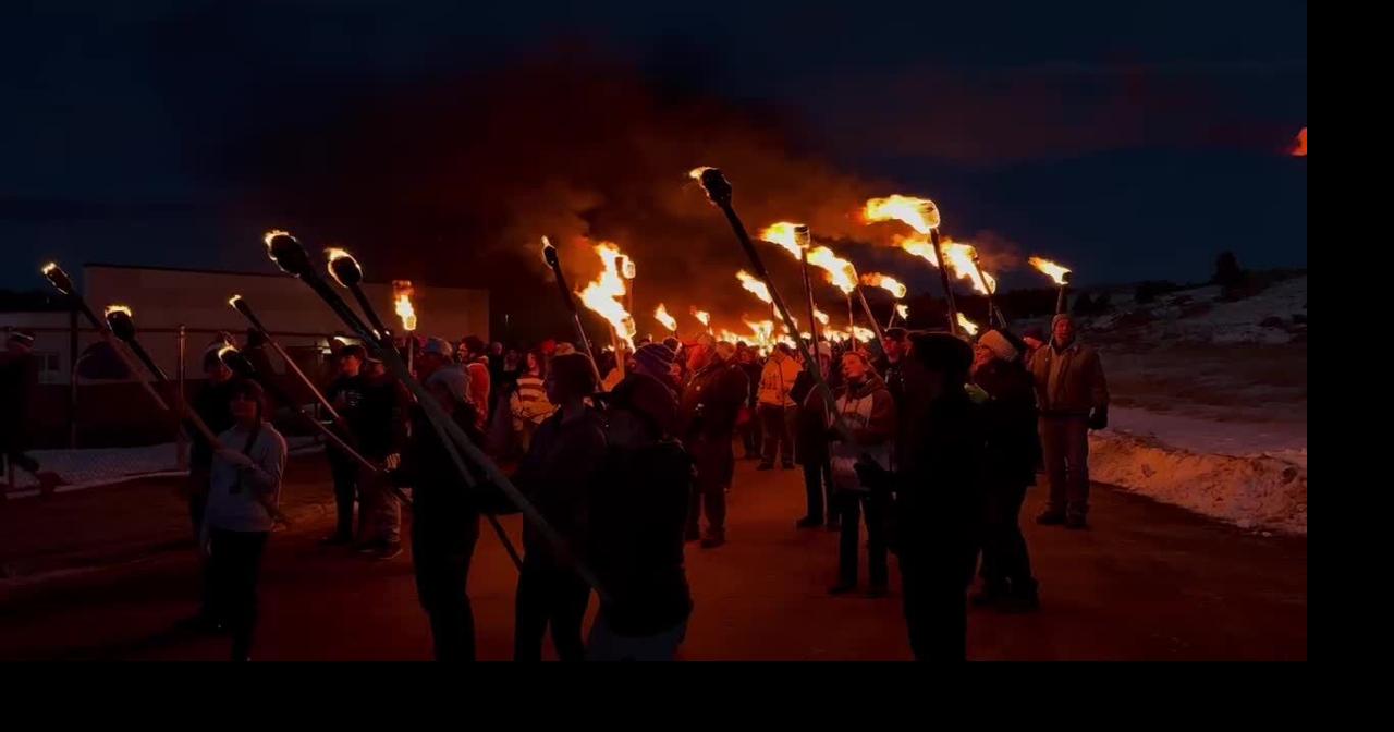 Torch carriers march through Custer chanting 'burn beetle burn'