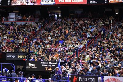 Montana fans cheer on tie-down roper Haven Meged during round 4 of the ...
