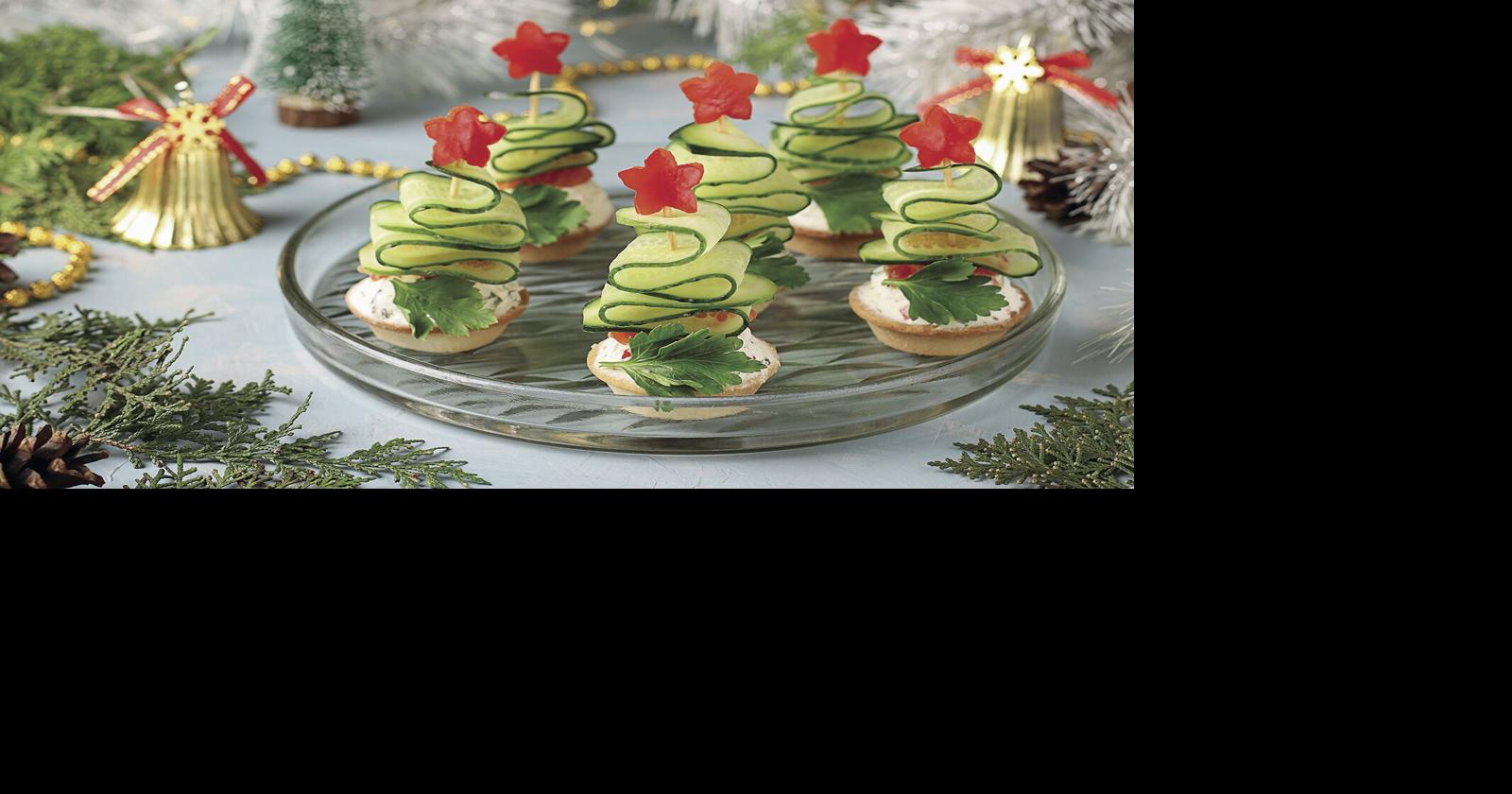 Festive canapes in the shape of Christmas trees made of cucumbers and ...