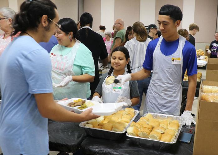 Seat at The Table: Volunteers dish up fellowship, meal to community ...