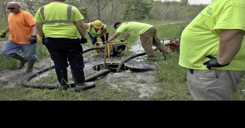 Sanitary workers busy at manhole spewing sewage | Local News ...