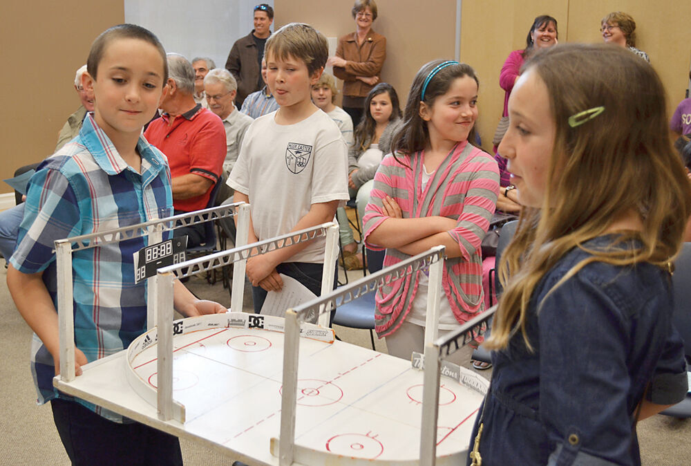 Students do their homework on rink plan