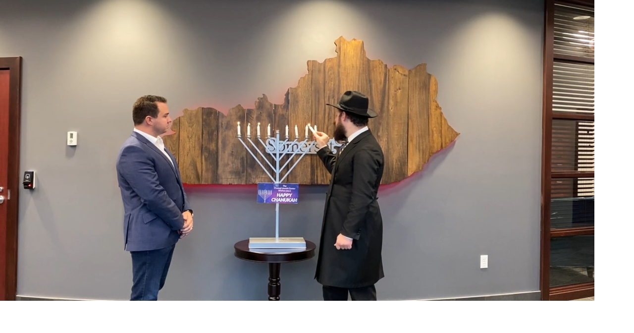 Rabbi Shlomo Litvin lights a menorah at the Somerset Energy Center ...