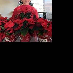 Welland boy delivers poinsettias and smiles to Woolcott Wing