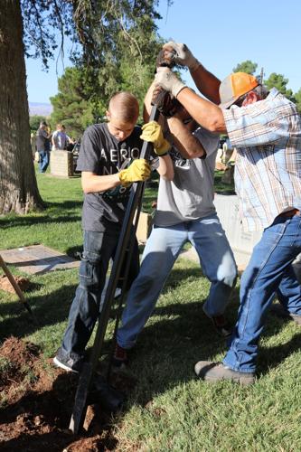 Boy Scout leads largest group of volunteers to level headstones at St ...