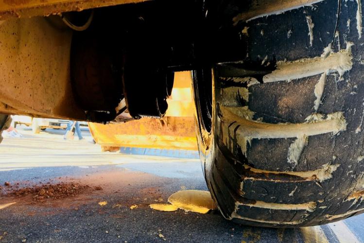 Huge construction scraper loses wheel, spills hydraulic fluid onto ...