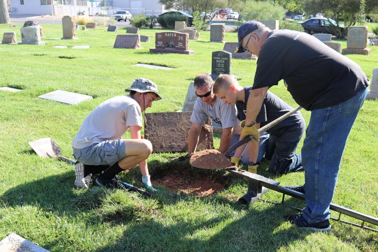 Boy Scout leads largest group of volunteers to level headstones at St ...