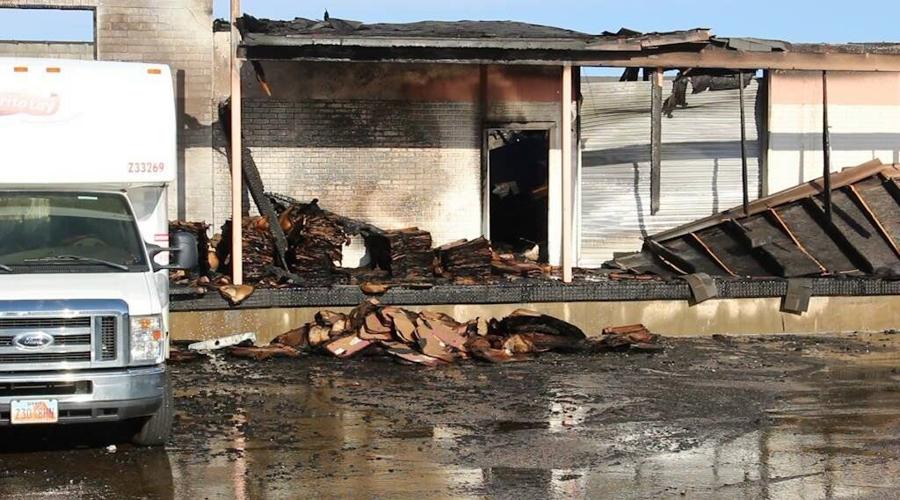 Firefighters called back to burnt-out warehouse after wind rekindles ...