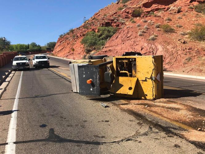 Hydraulic fluid spills across roadway when asphalt roller tips over on ...