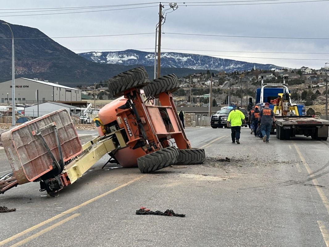 Driver loses load as boom lift tips off trailer onto Cedar City's ...