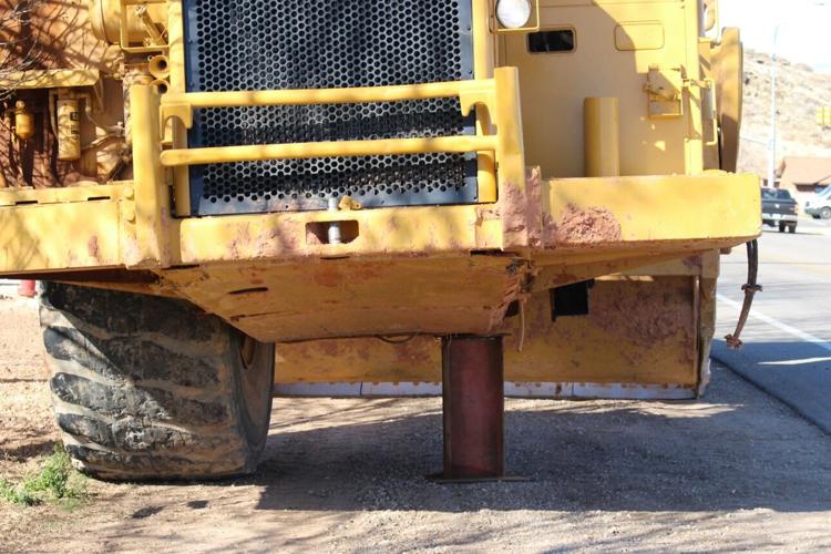 Huge construction scraper loses wheel, spills hydraulic fluid onto ...