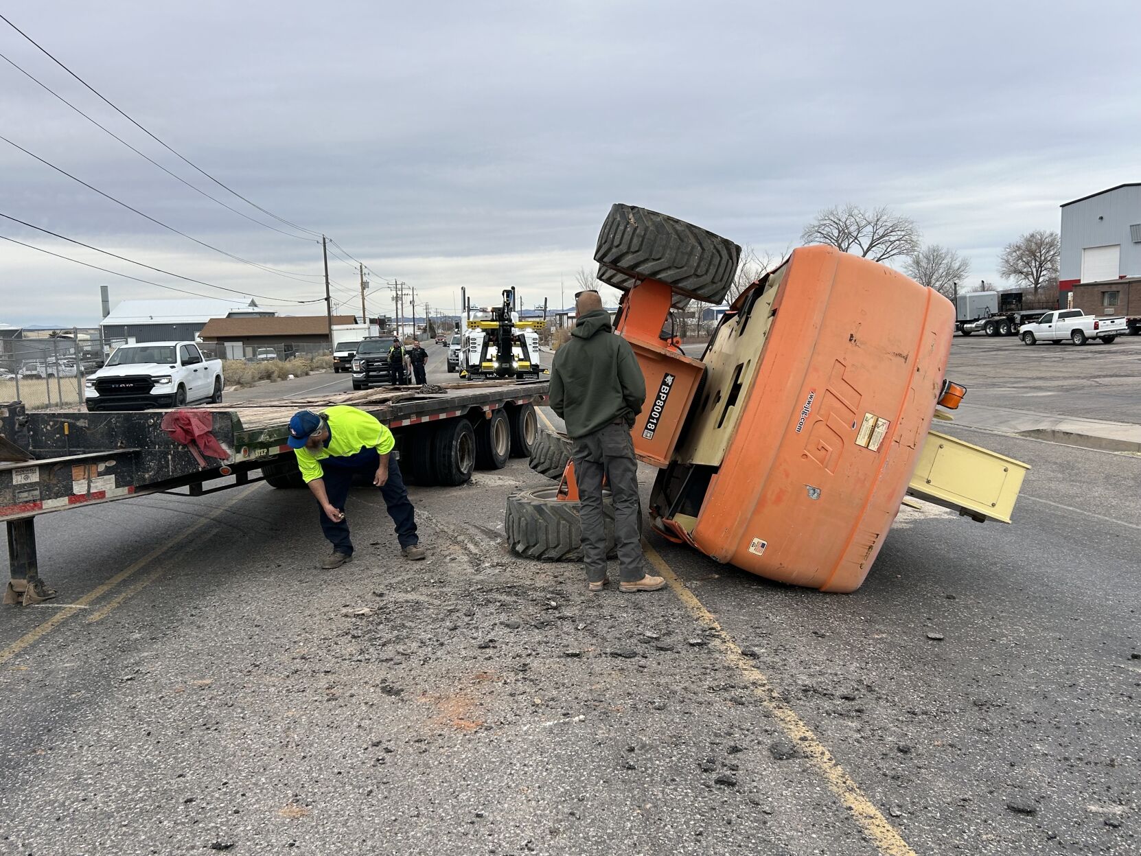 Driver loses load as boom lift tips off trailer onto Cedar City's ...
