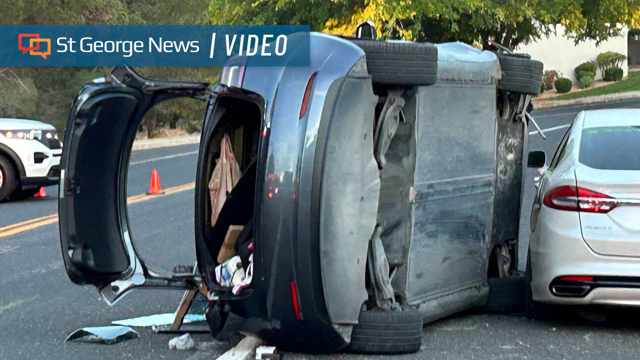 Driver unhurt after Tesla rolls, slides to a stop beside parked vehicle ...