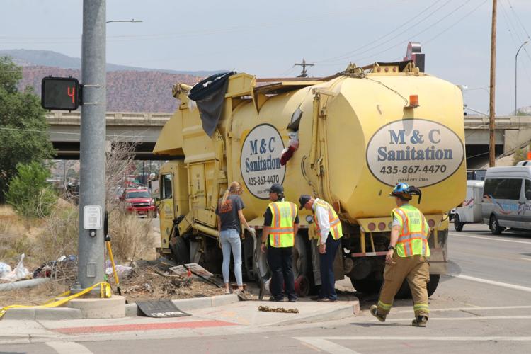 Garbage truck crash spills trash, takes out light pole and hydrant in ...