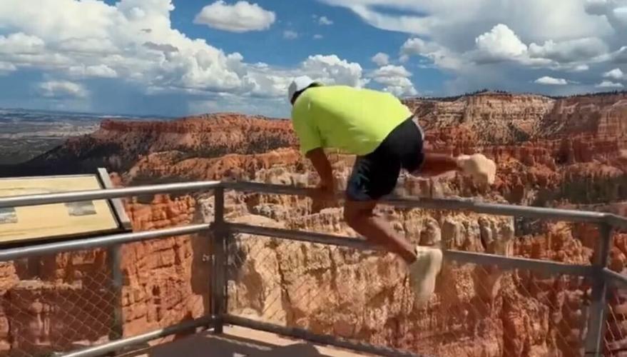 Park officials reviewing viral video of man jumping over railing at ...