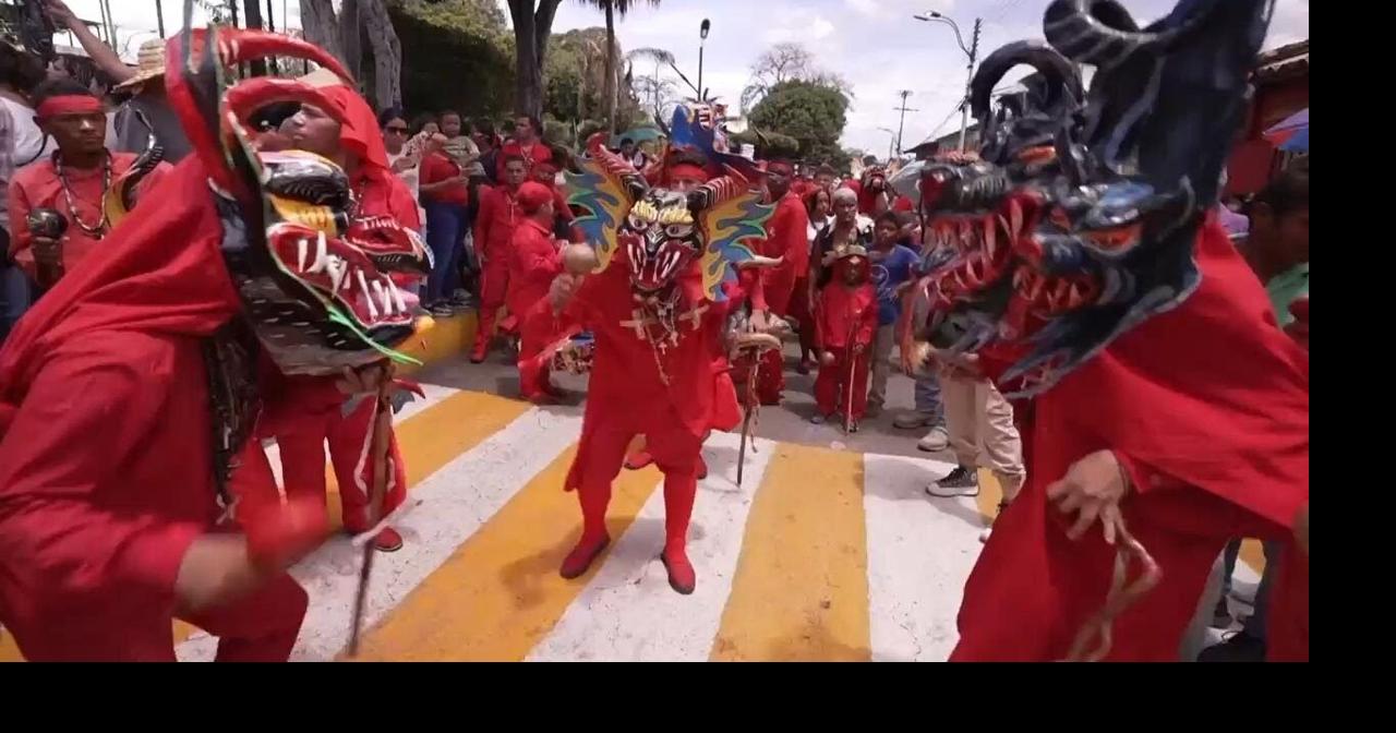 In the streets of Yare, Venezuela dancing red devils give thanks for ...